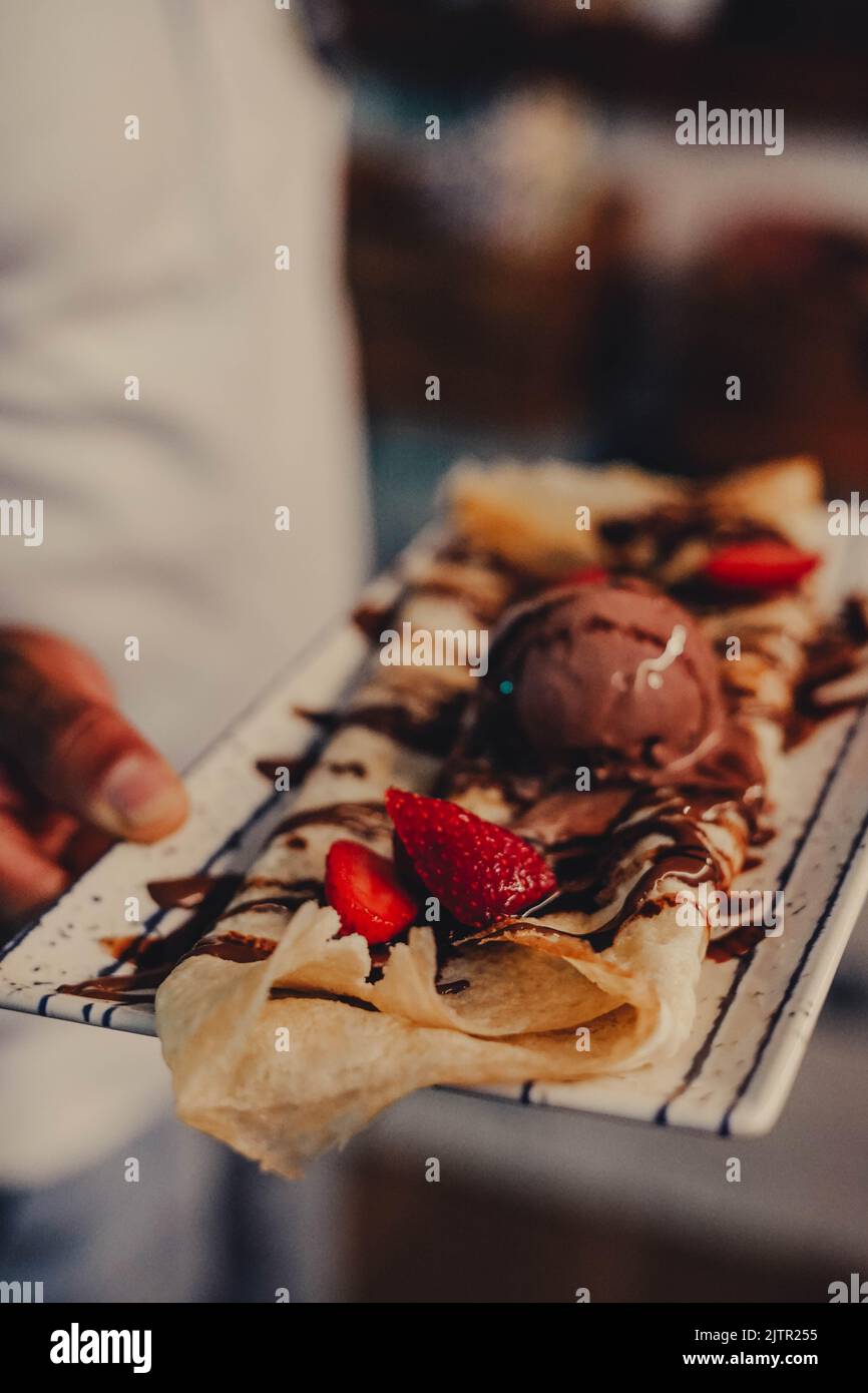 Delicious nutella and chocolate syrup crepe, with a scoop of ice cream ...