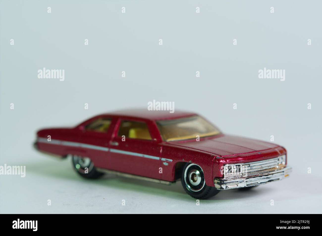 dark red retro toy car on white background, front view Stock Photo - Alamy