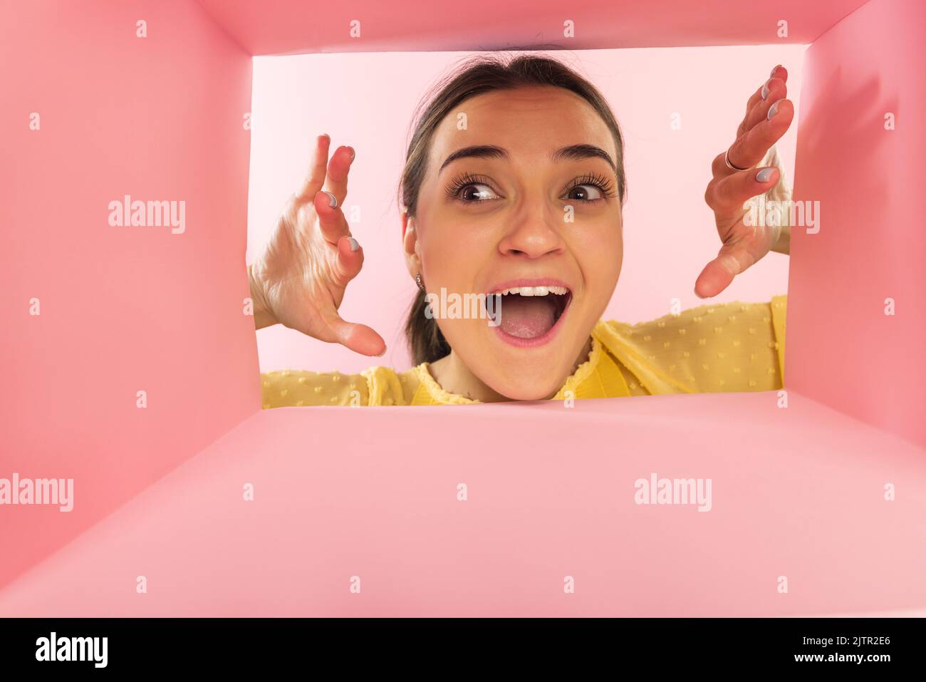 Happy and excited young woman looking inside carton box. Receiving long ...