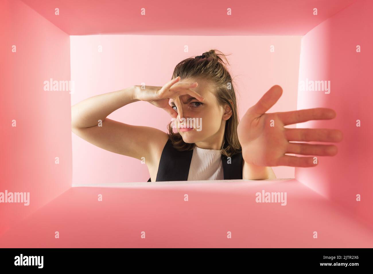 Young woman looking inside carton box and closing nose. Bad smelling ...