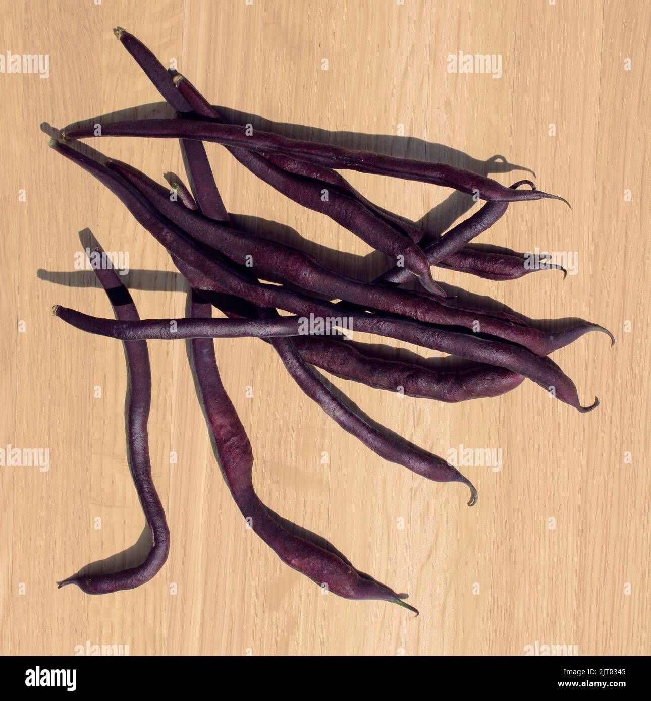 Purple Pole Beans on a Wood Background Stock Photo - Alamy