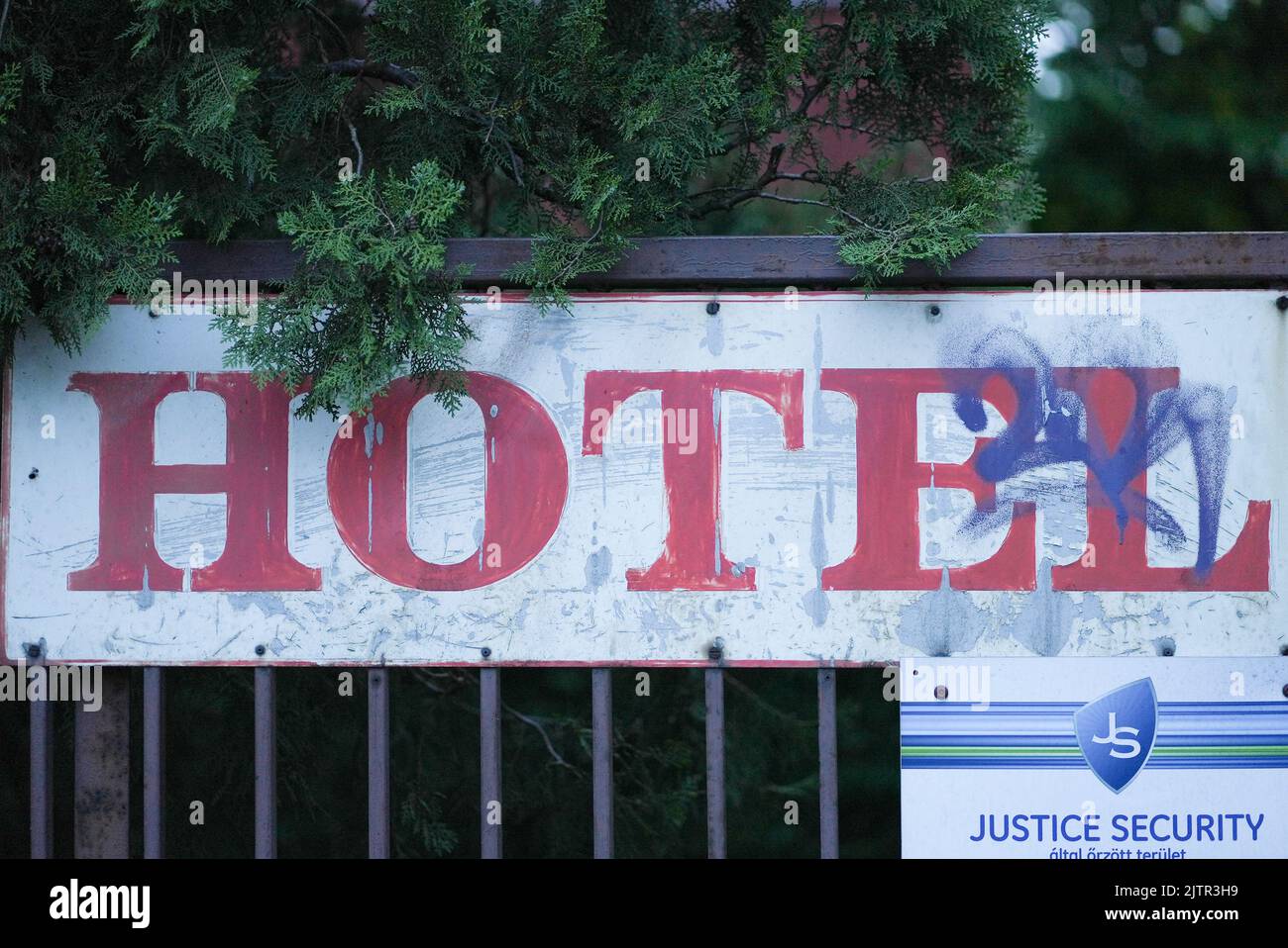 Scary old hotel sign on a gate Stock Photo - Alamy