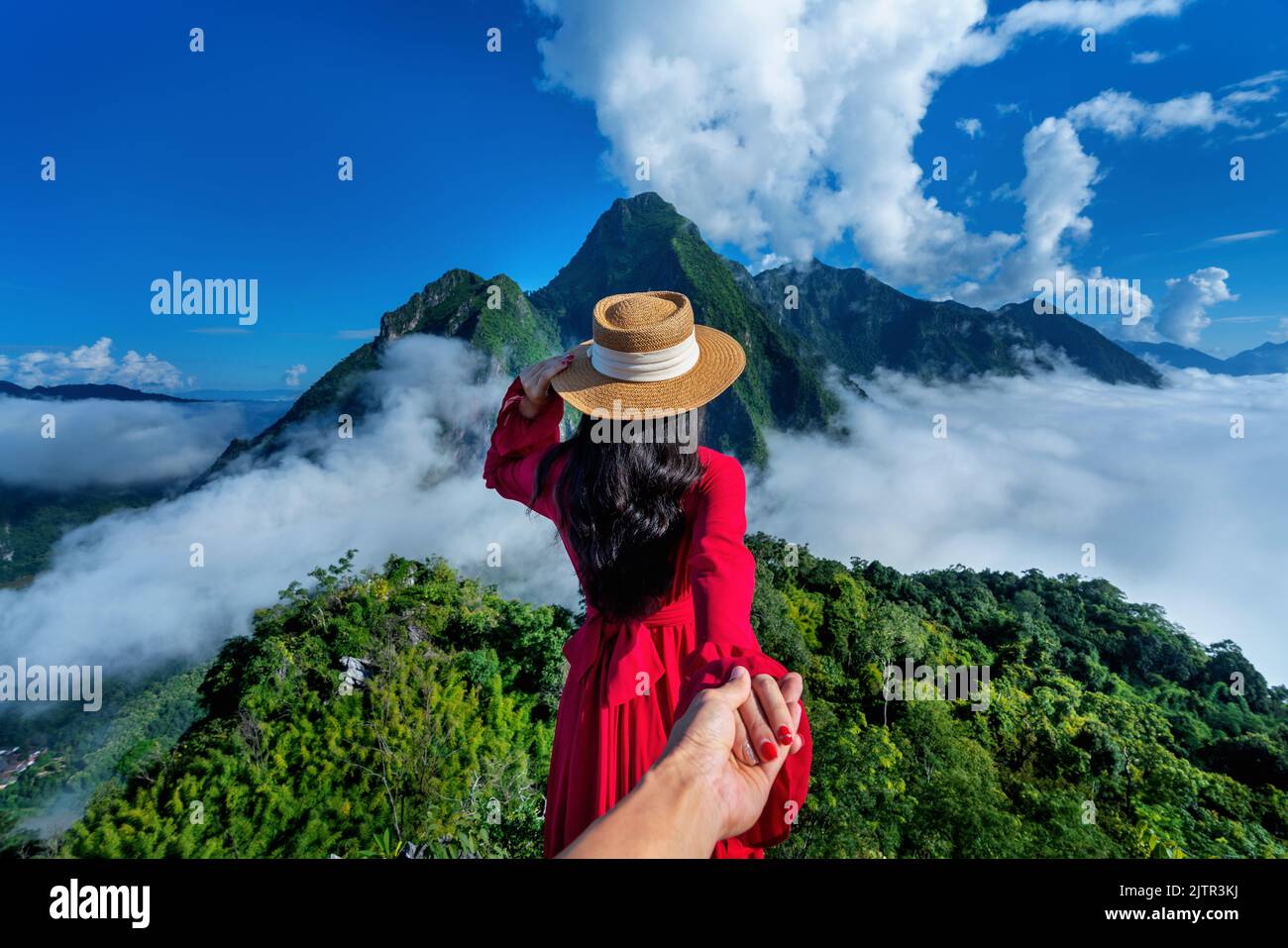 Women tourists holding man's hand and leading him to Pha dang viewpoint ...