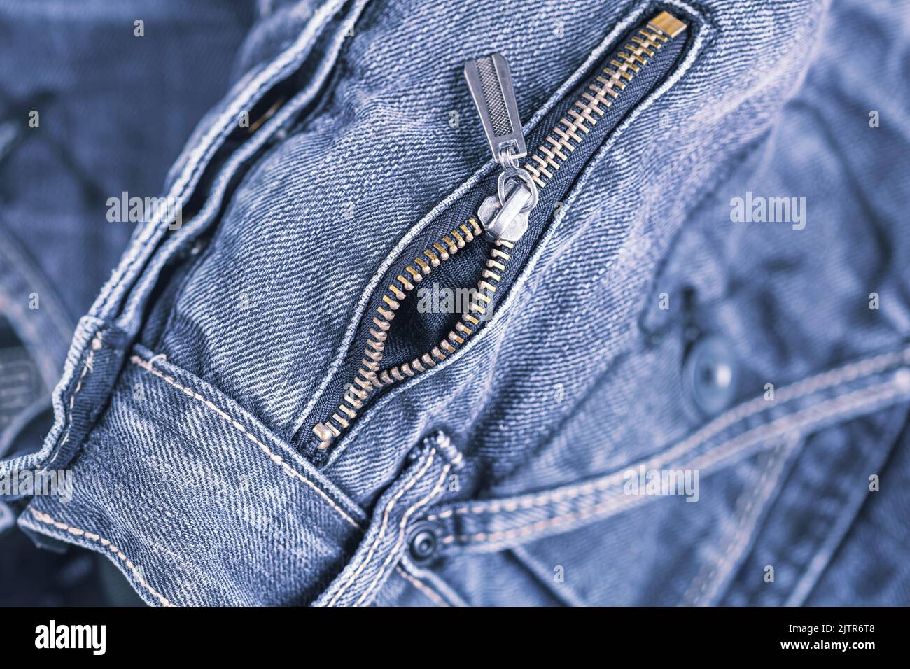 A denium blue jean closeup. View of old jeans details with zipper ...