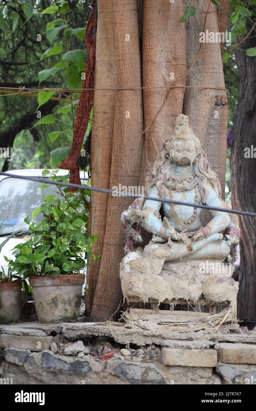 Idols of Hindu gods under a tree Stock Photo - Alamy
