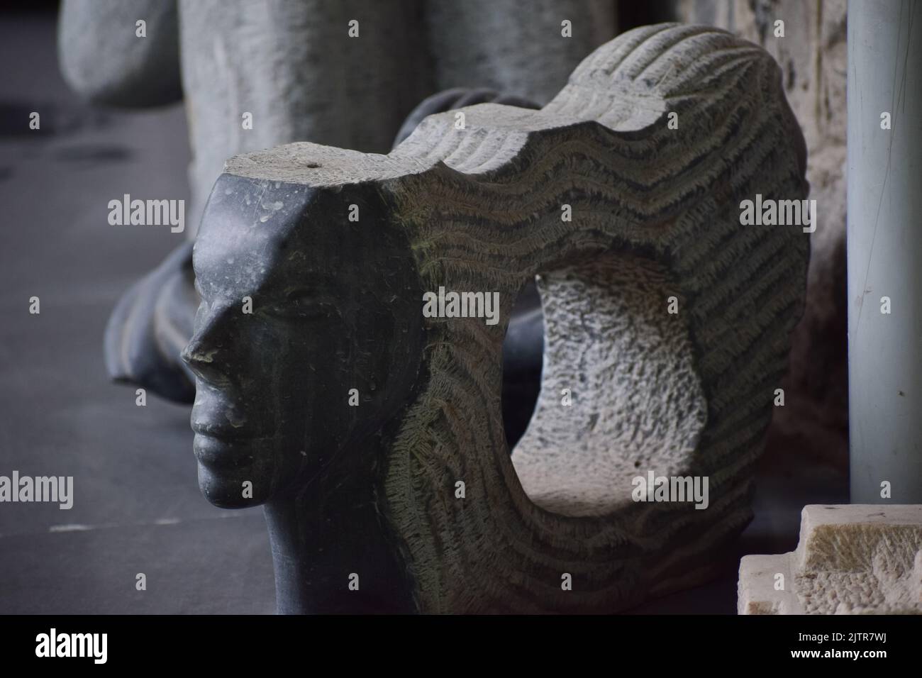 Sculptor with human face which is carved in stone Stock Photo - Alamy