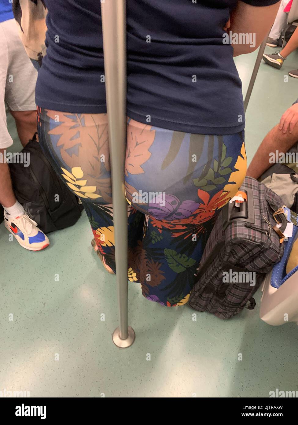 Woman with a large bottom, leaning on a pole, Athens subway, Athens ...