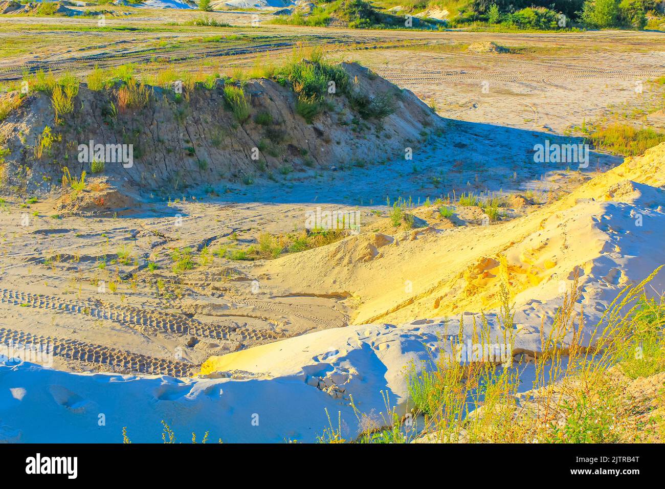Excavated sand mountains and rubble piles quarry lake dredging pond ...