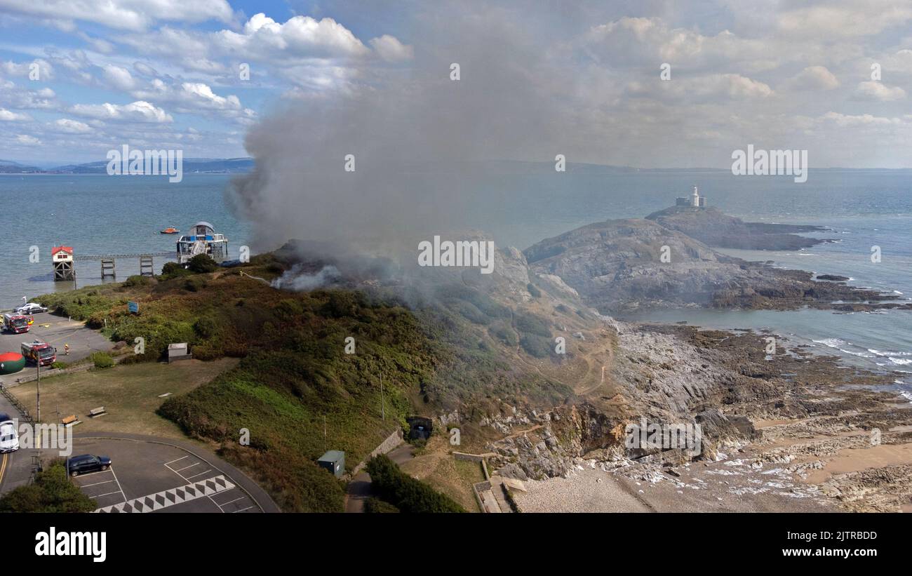 The cliffs catch fire above the old Cinderella's nightclub at Mumbles ...