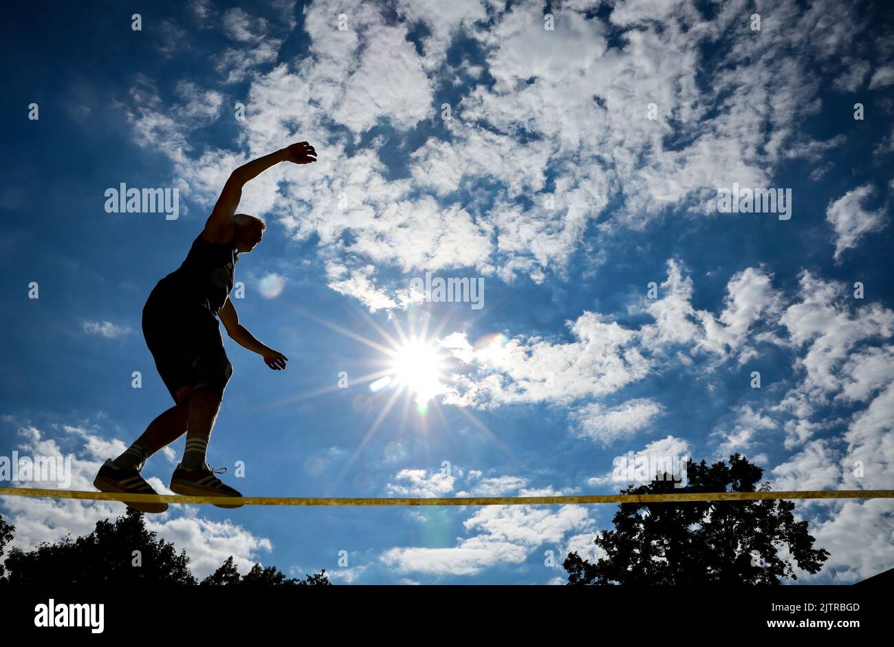 01 September 2022, Saxony, Chemnitz: A man balances on a slackline in ...