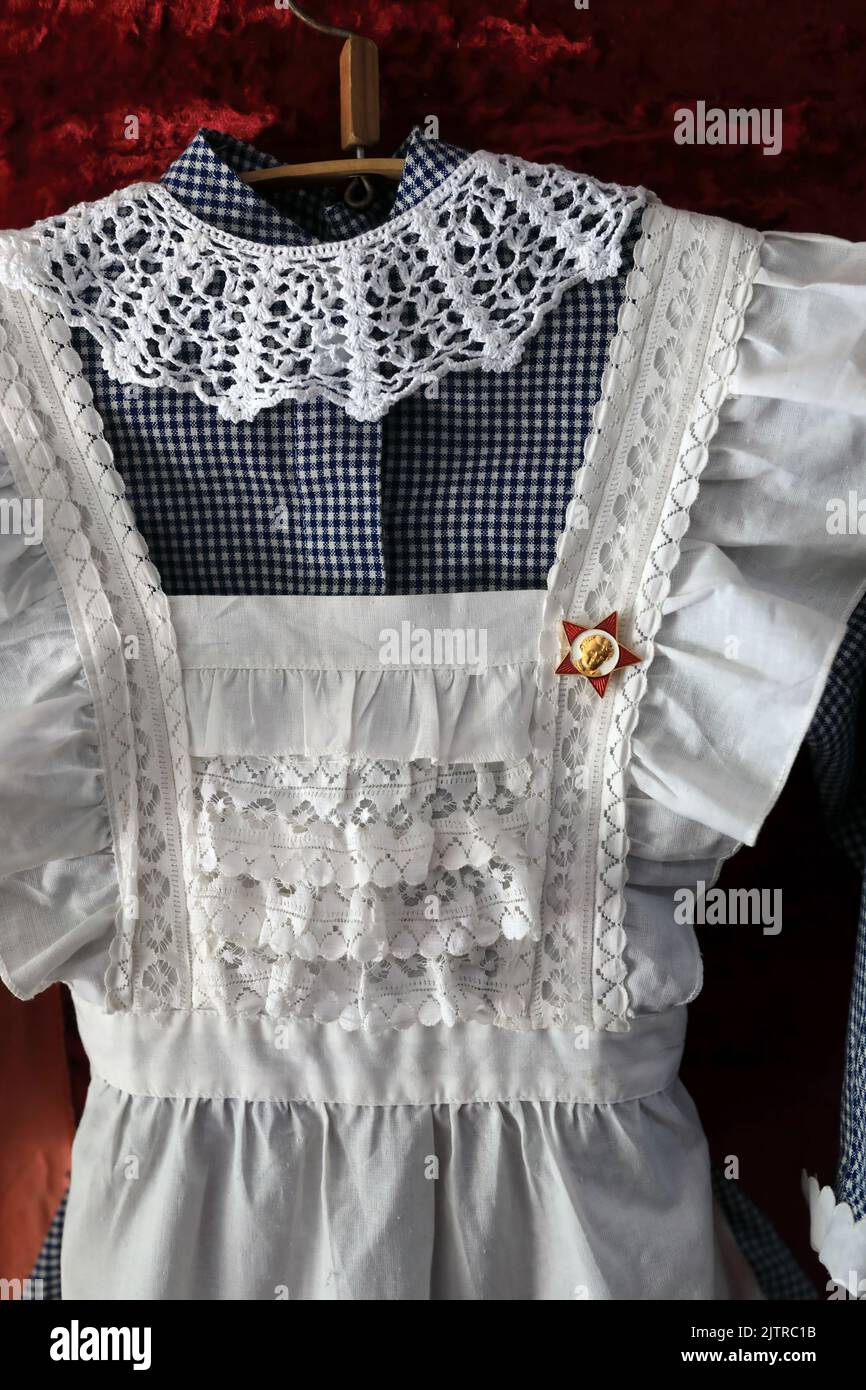 View of soviet girl's school uniform with October badge Stock Photo - Alamy
