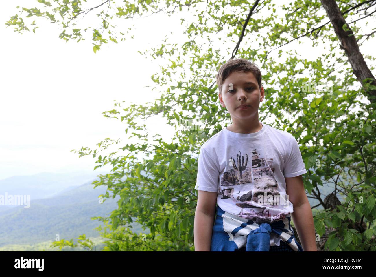 Portrait of kid on Azish-Tau ridge background, Adygea Stock Photo - Alamy