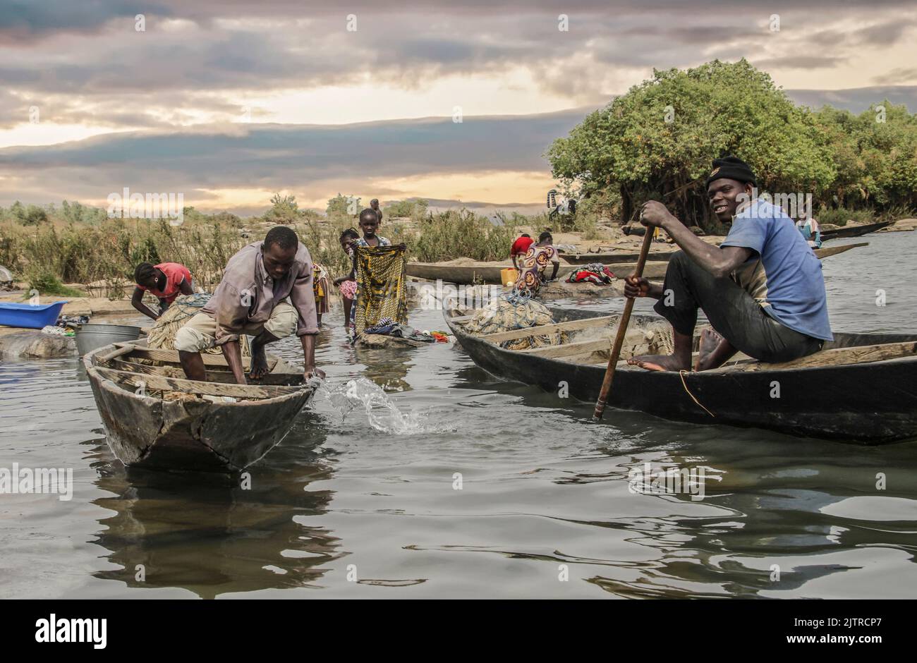 Mali, Africa. Black man fishing on the wood merchant boats on the Niger ...