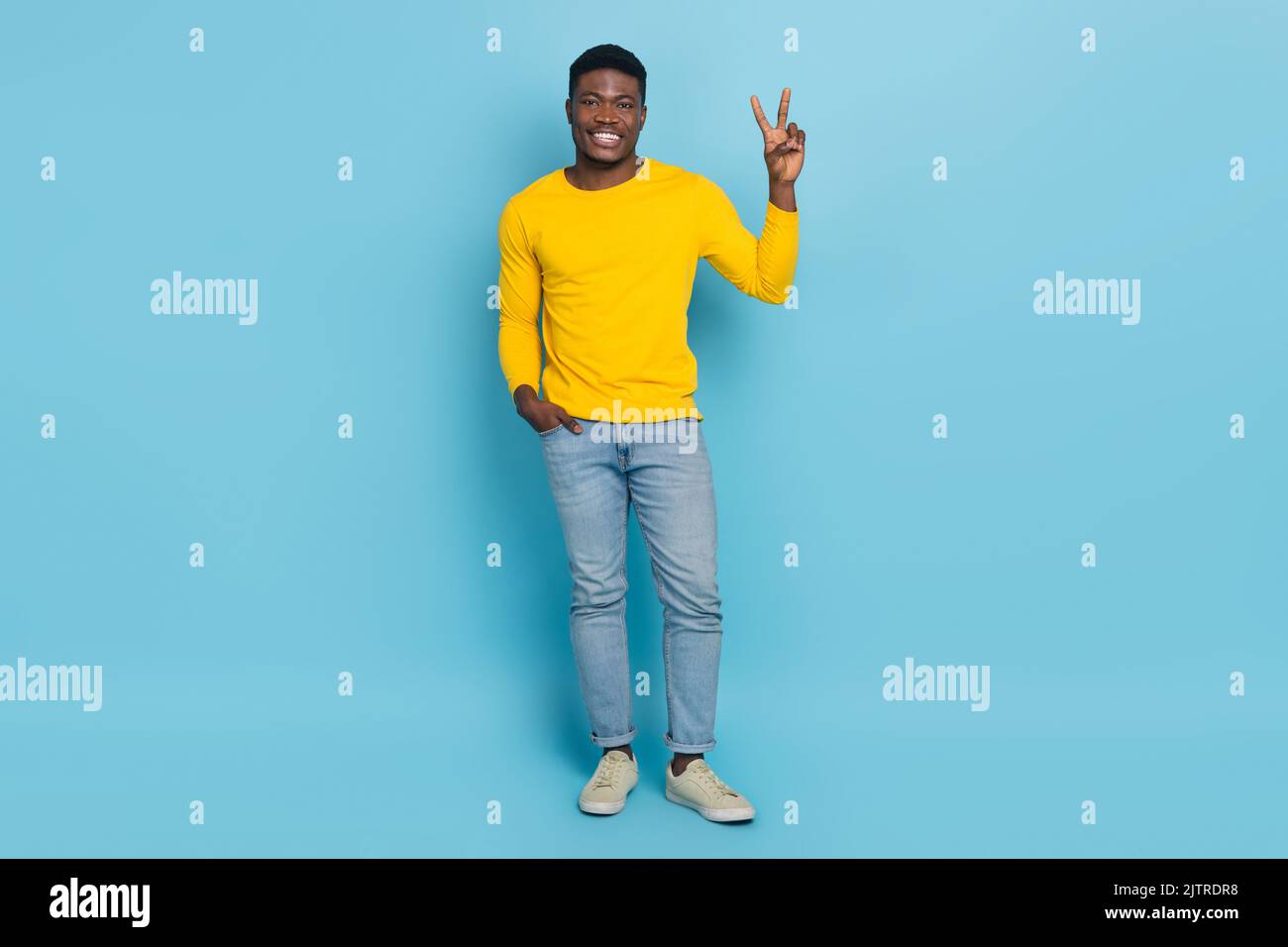Full length photo of handsome dude showing v-sign hippie symbol wear ...