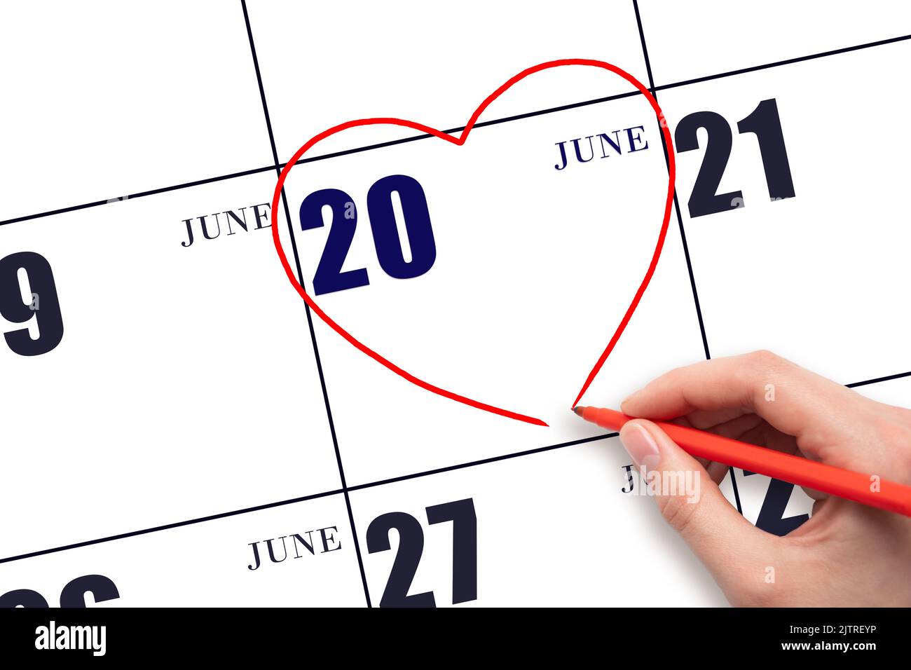 20th day of June. A woman's hand drawing a red heart shape on the ...
