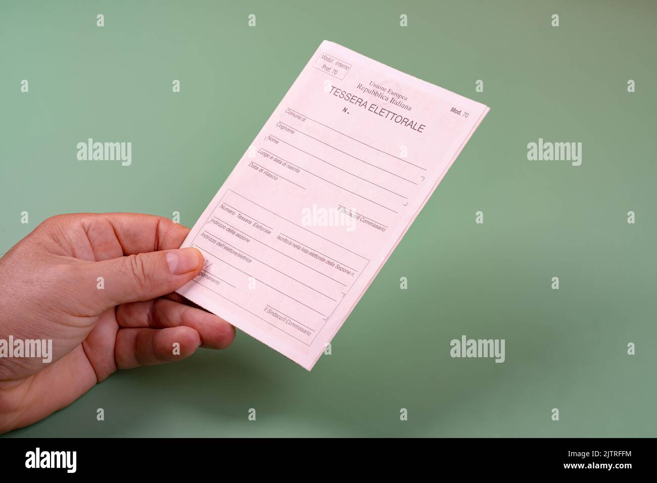 a man with a voting card for access to polling stations for voting in ...