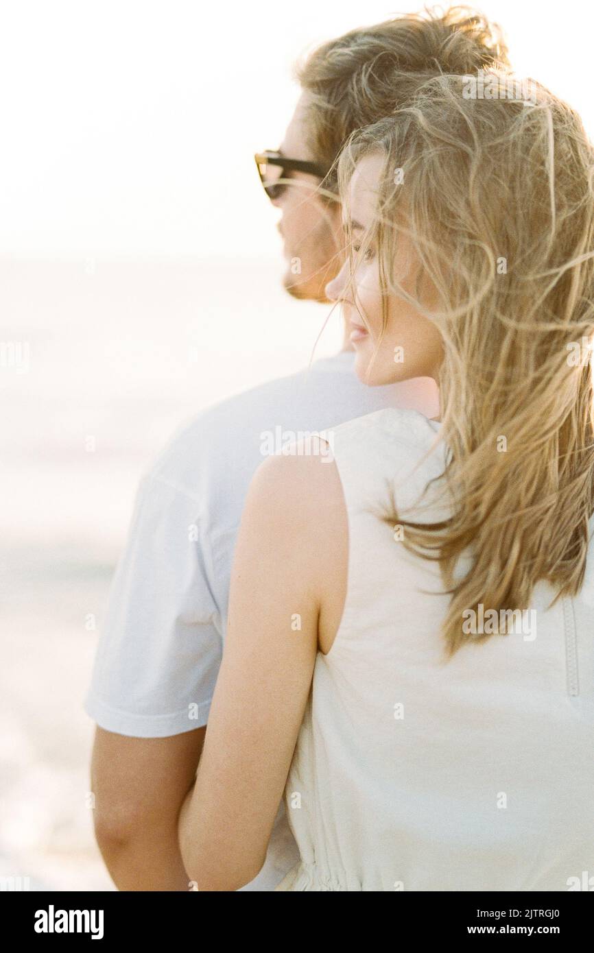 Woman hugging man from behind. Back view Stock Photo - Alamy