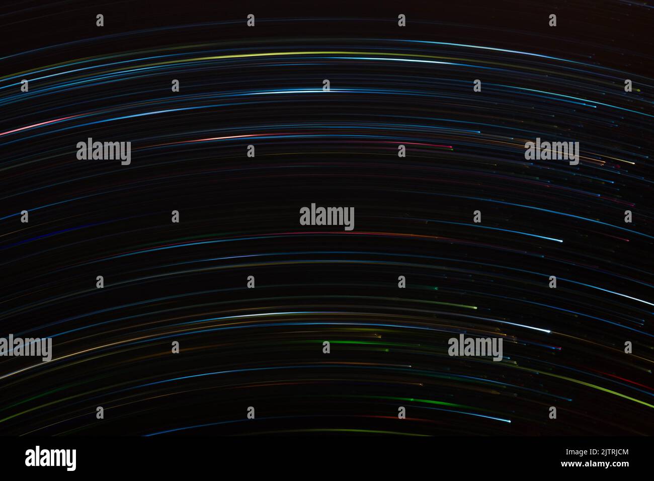 Glowing multicolor arc lines. Sparkles and lights in motion. Dark ...