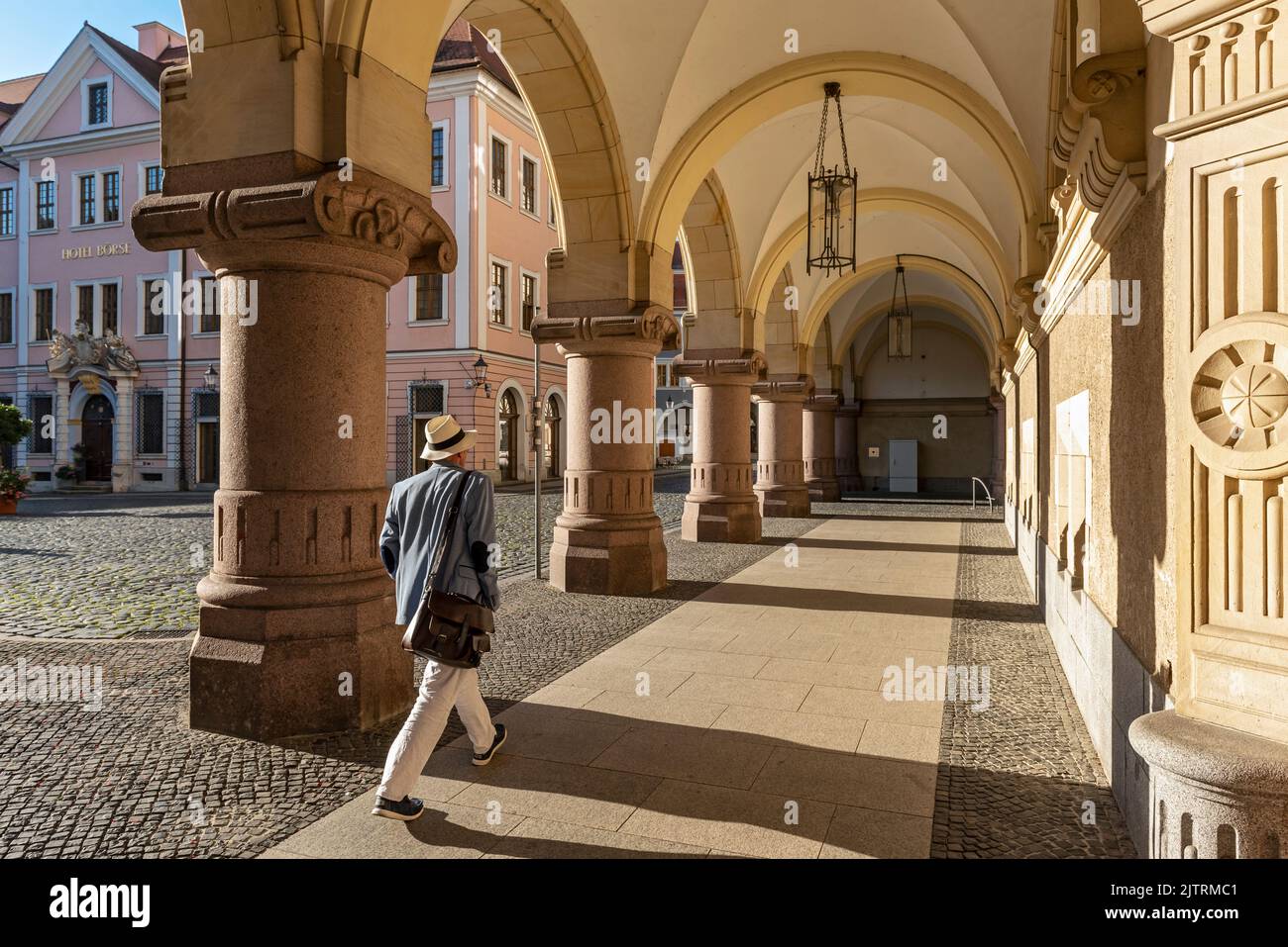 Man walks under the arcade of New Town Hall building, Lower Market ...