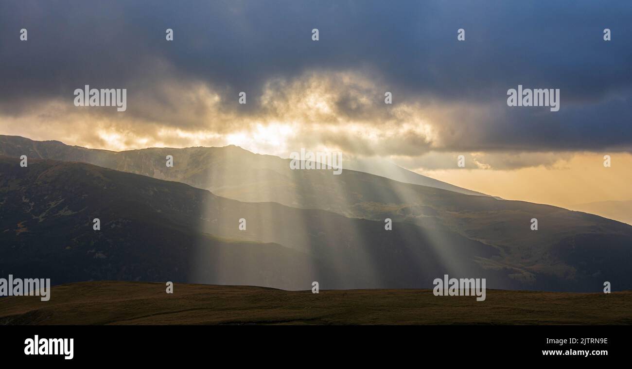 Beautiful ray of sunlight breaking through clouds at sunset Stock Photo - Alamy
