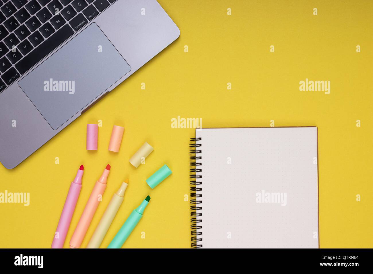 Laptop, notepad, colored pencils. back to school. Isolated yellow ...