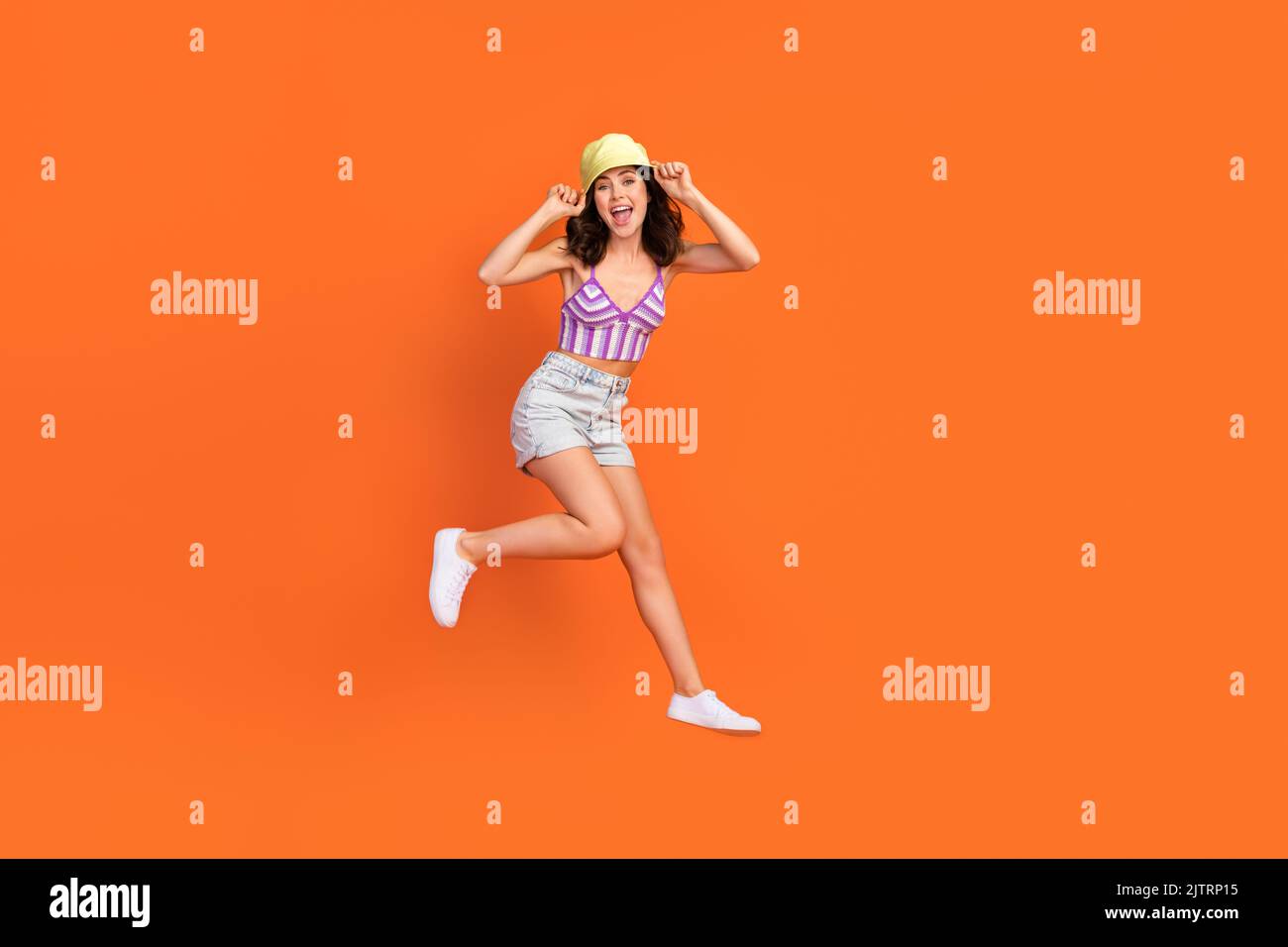 Full size photo of brunette impressed lady jump wear cap top shorts ...