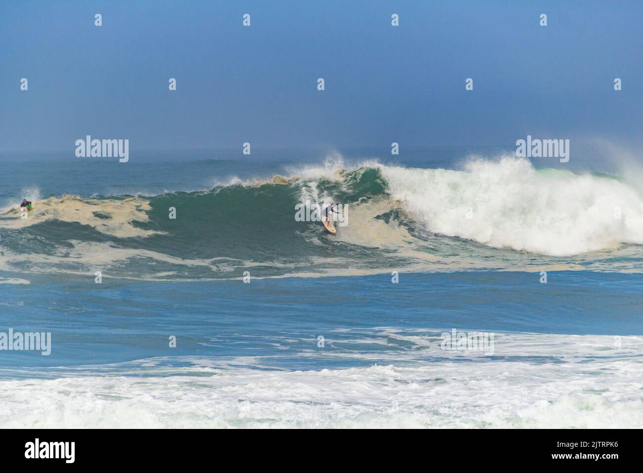 surfer riding a wave at leblon beach in Rio de Janeiro, Brazil - April ...