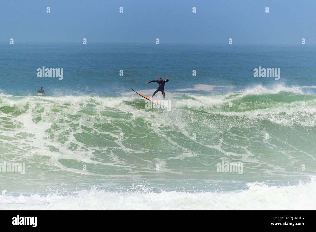 surfer riding a wave at leblon beach in Rio de Janeiro, Brazil - April ...