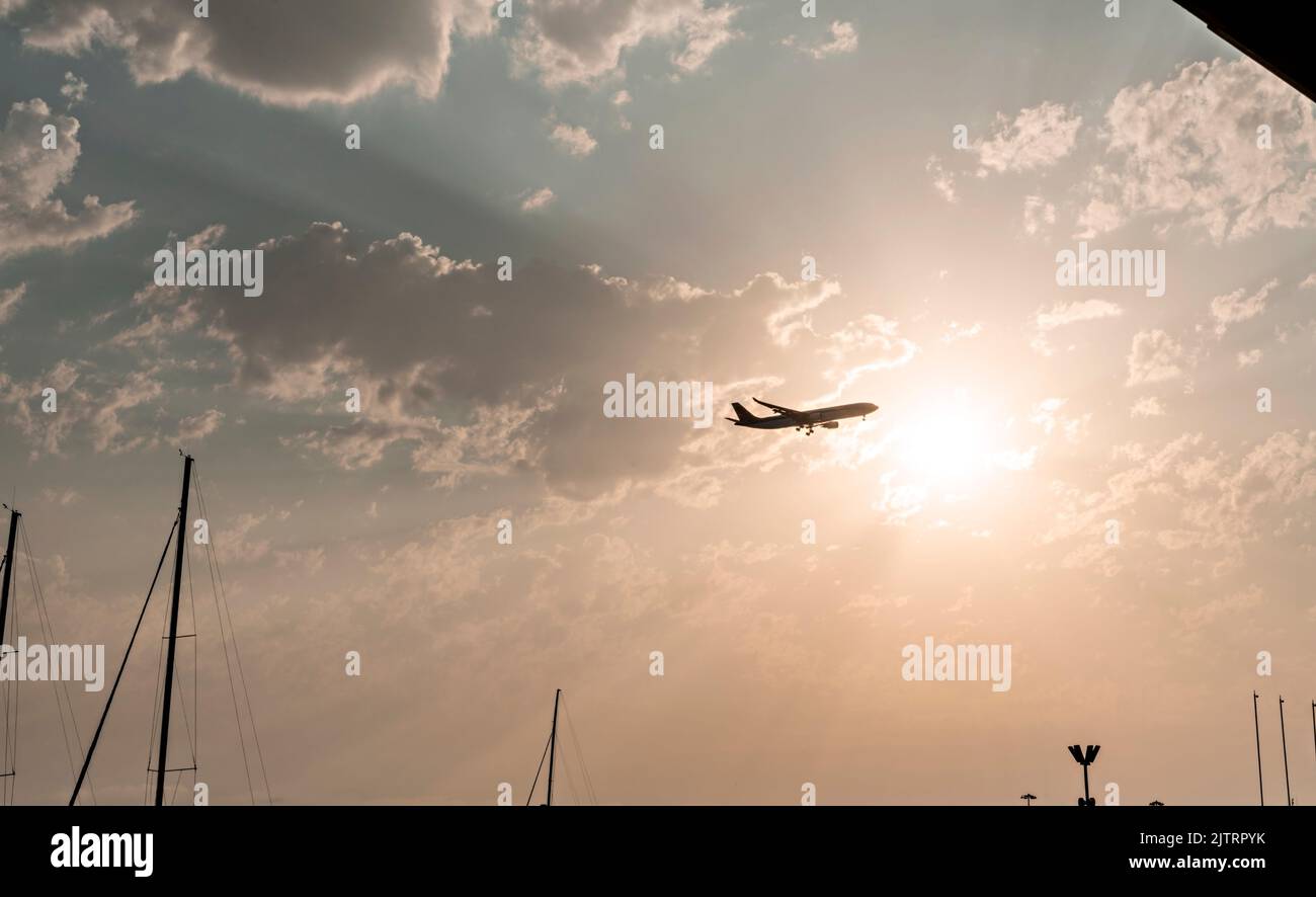 Airplane flying in the sky against the backdrop of beautiful pink ...