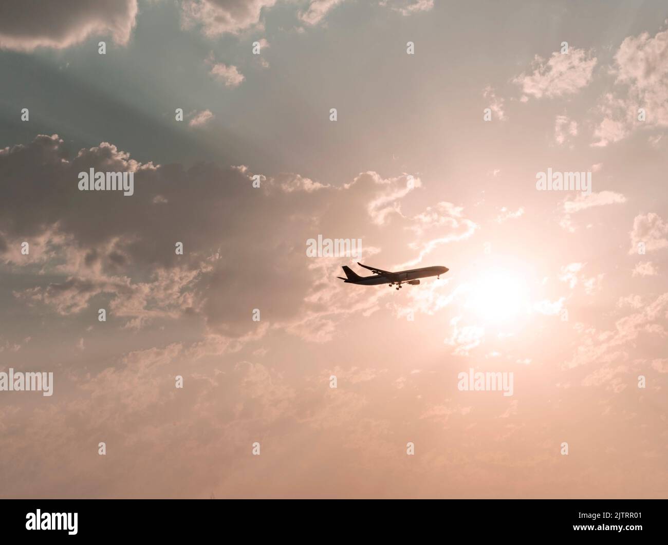 Airplane flying in the sky against the backdrop of beautiful pink ...