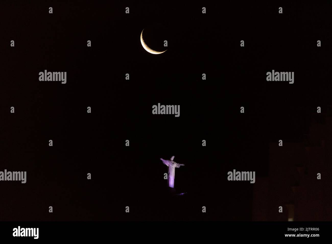 Crescent moon and the statue of Christ the Redeemer in Rio de Janeiro ...