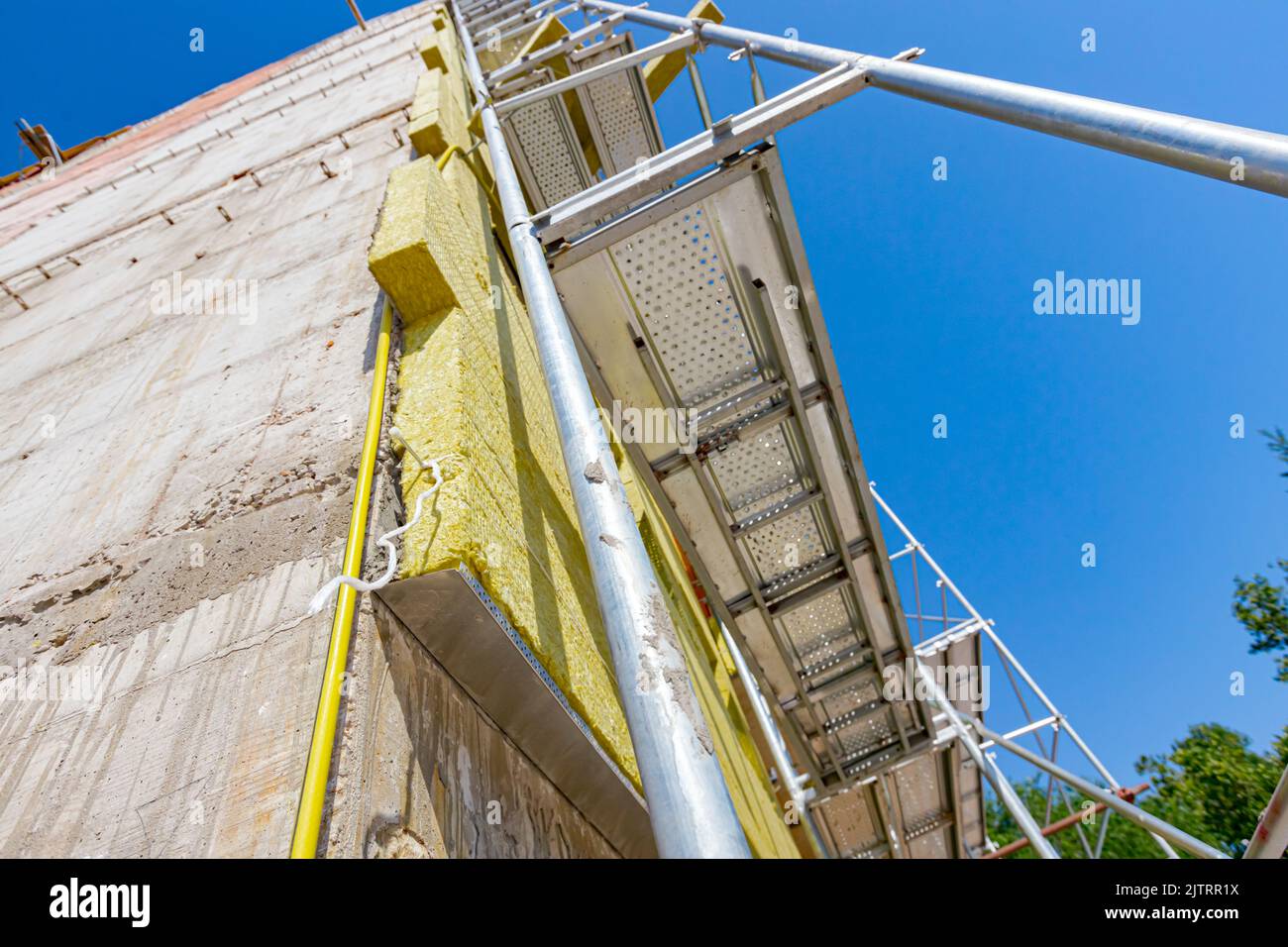 View from below on the metal scaffold that is placed against unfinished ...