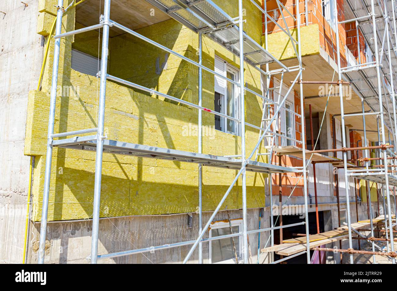 Applying thermal isolation stone wool on the brick wall of residential ...