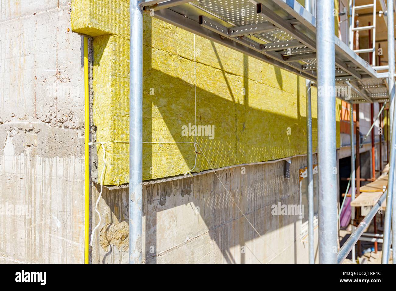 Applying thermal isolation stone wool on the brick wall of residential ...