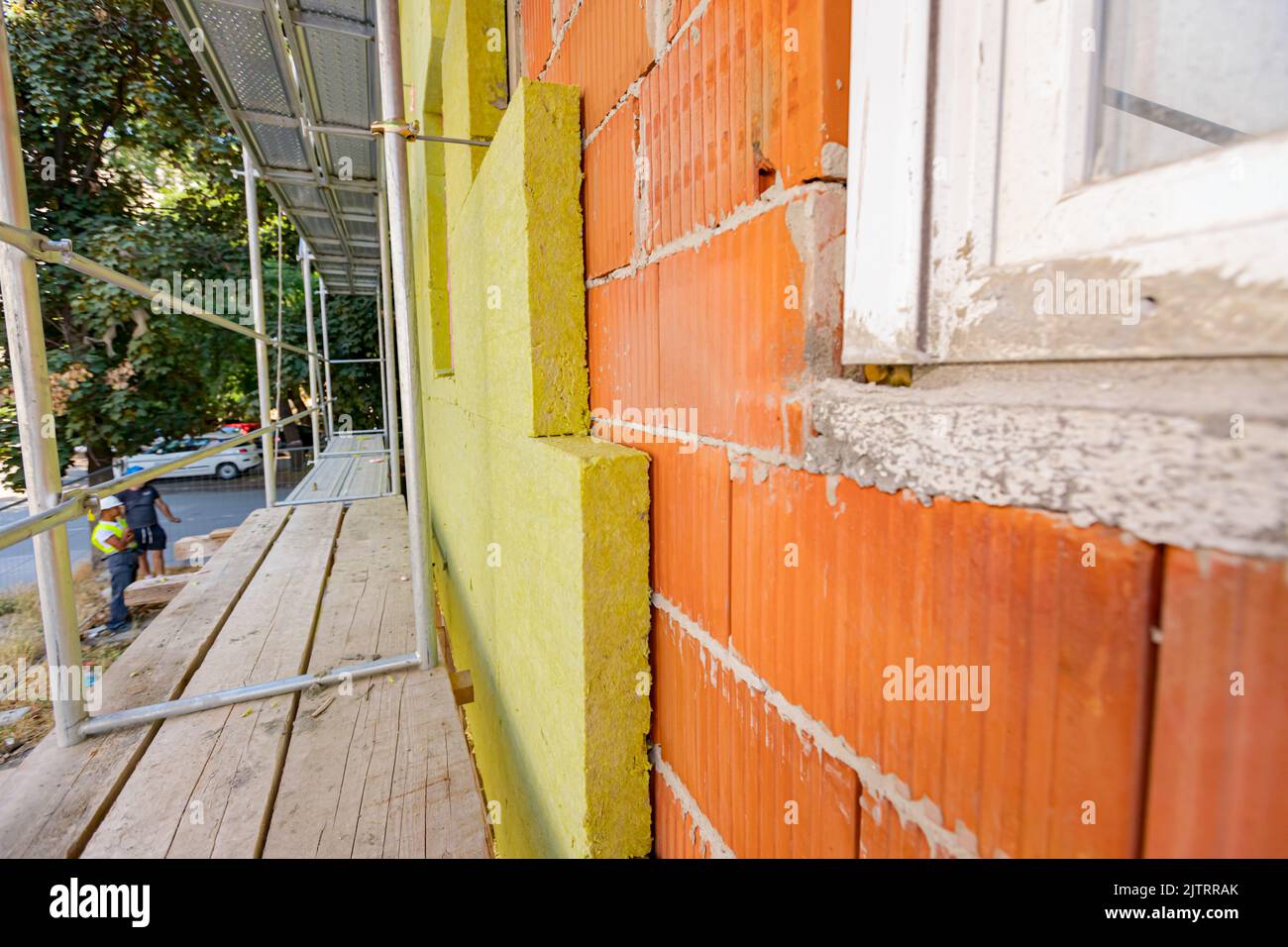 Applying thermal isolation stone wool on the brick wall of residential ...
