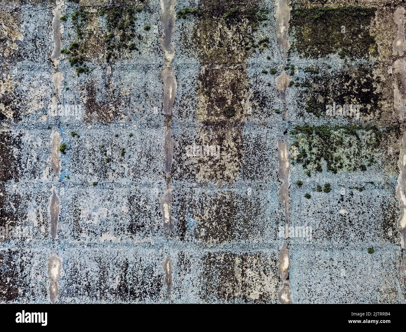 Dirty old eroded cracked plaster cement block fence. Concrete block ...