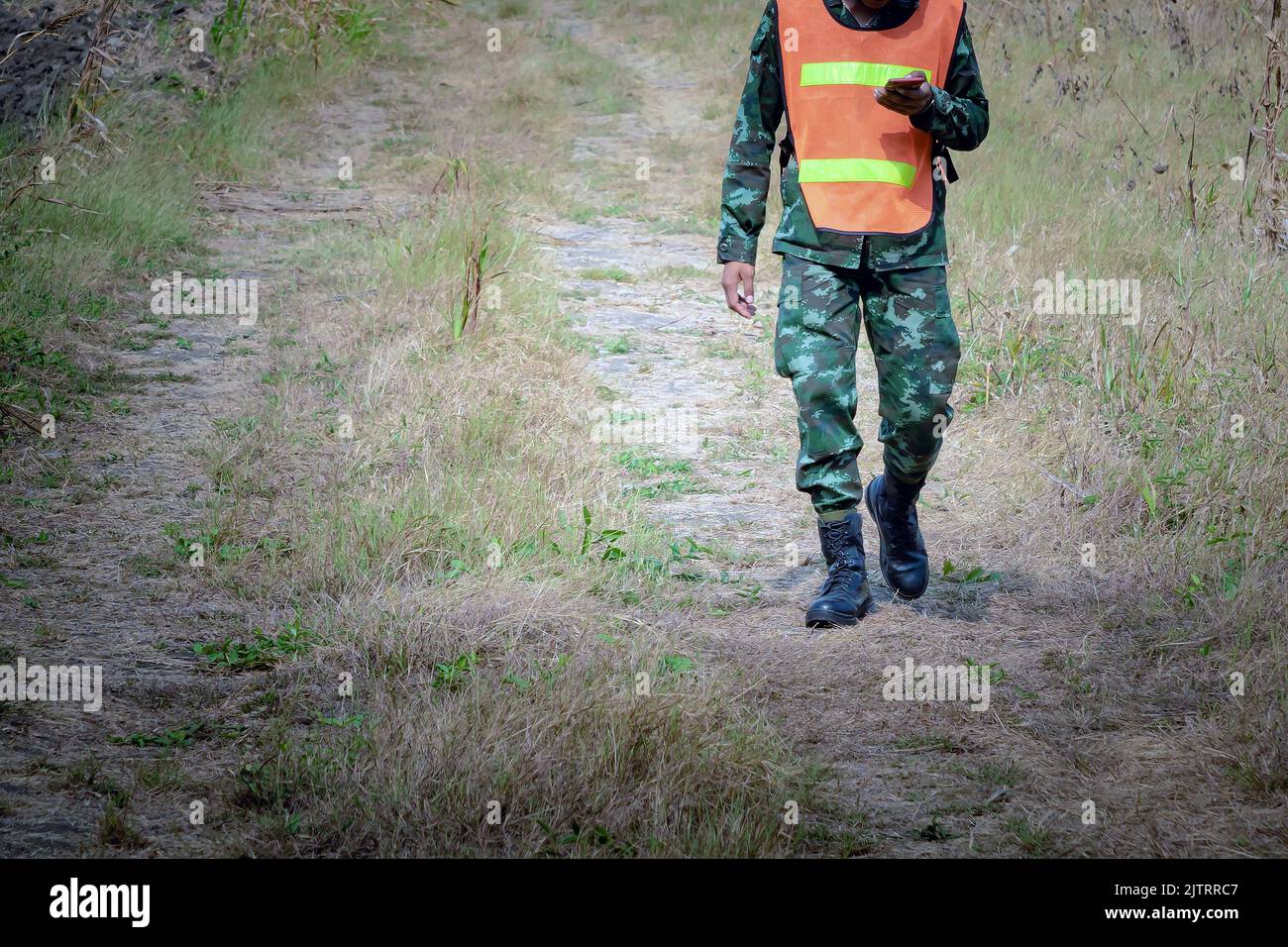 Reconnaissance infantry using cell phones in fields to send news to ...