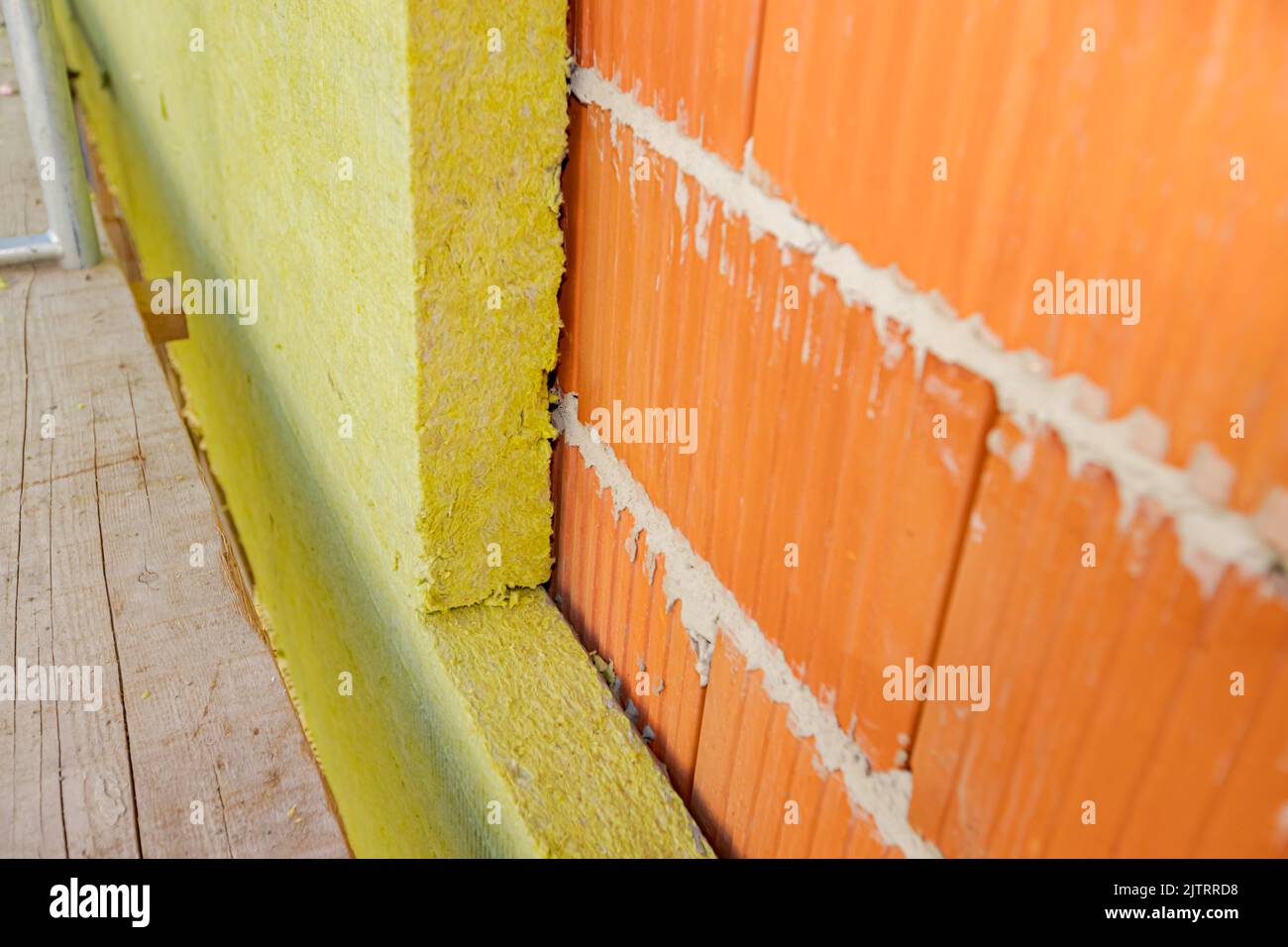 Applying thermal isolation stone wool on the brick wall of residential ...