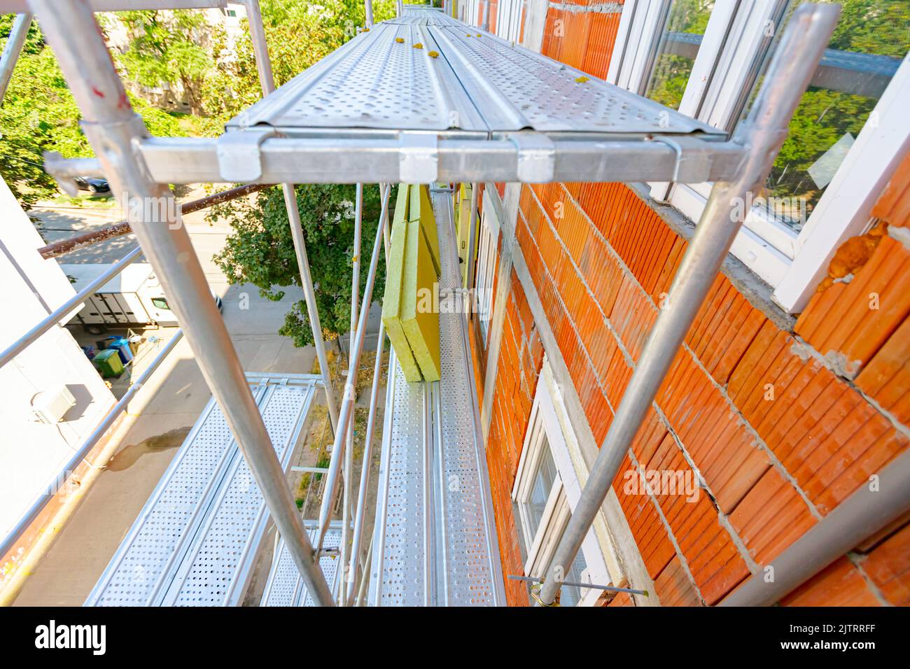 Rock wool panels lined up on scaffolding, waiting for installation ...