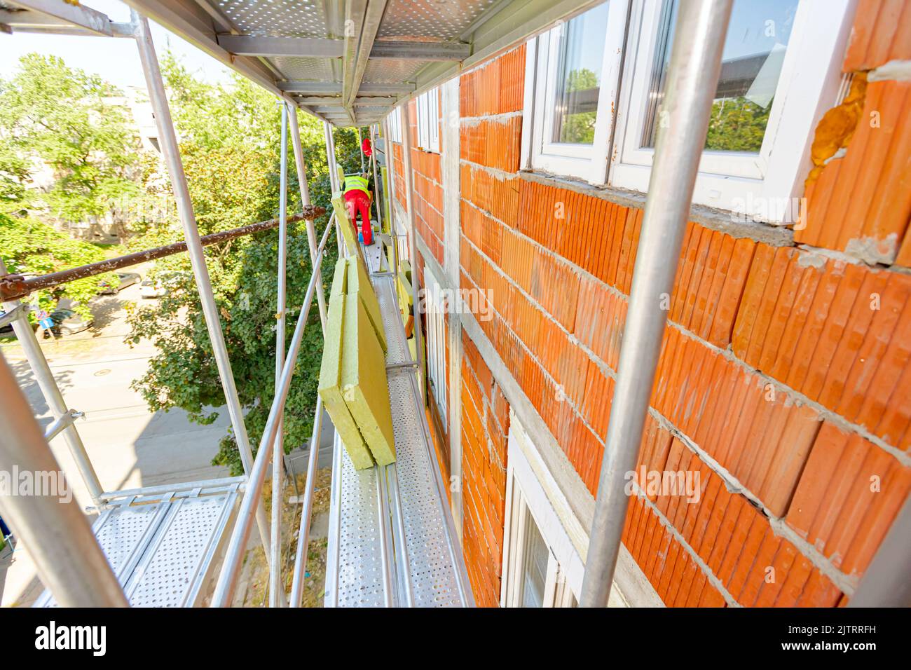 Rock wool panels lined up on scaffolding, waiting for installation ...