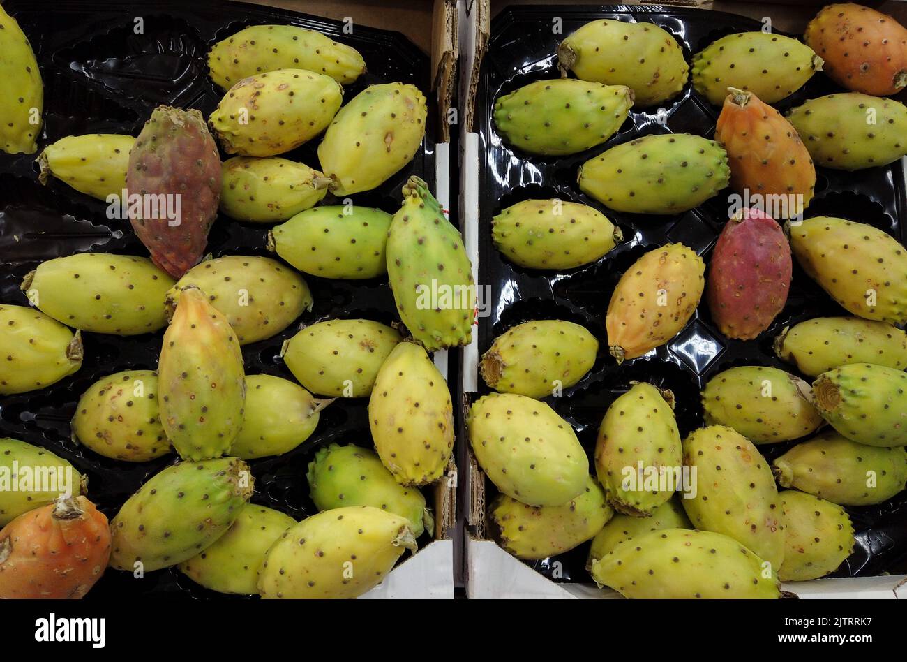 Top view of fresh ripe whole Prickly Pears in box at the market stall ...