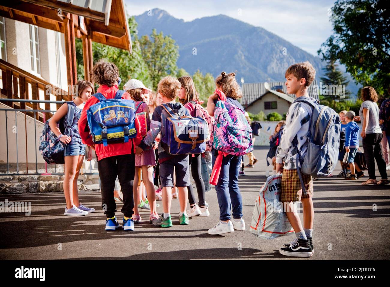Pupils in the courtyard of their primary schoolyard just before ...