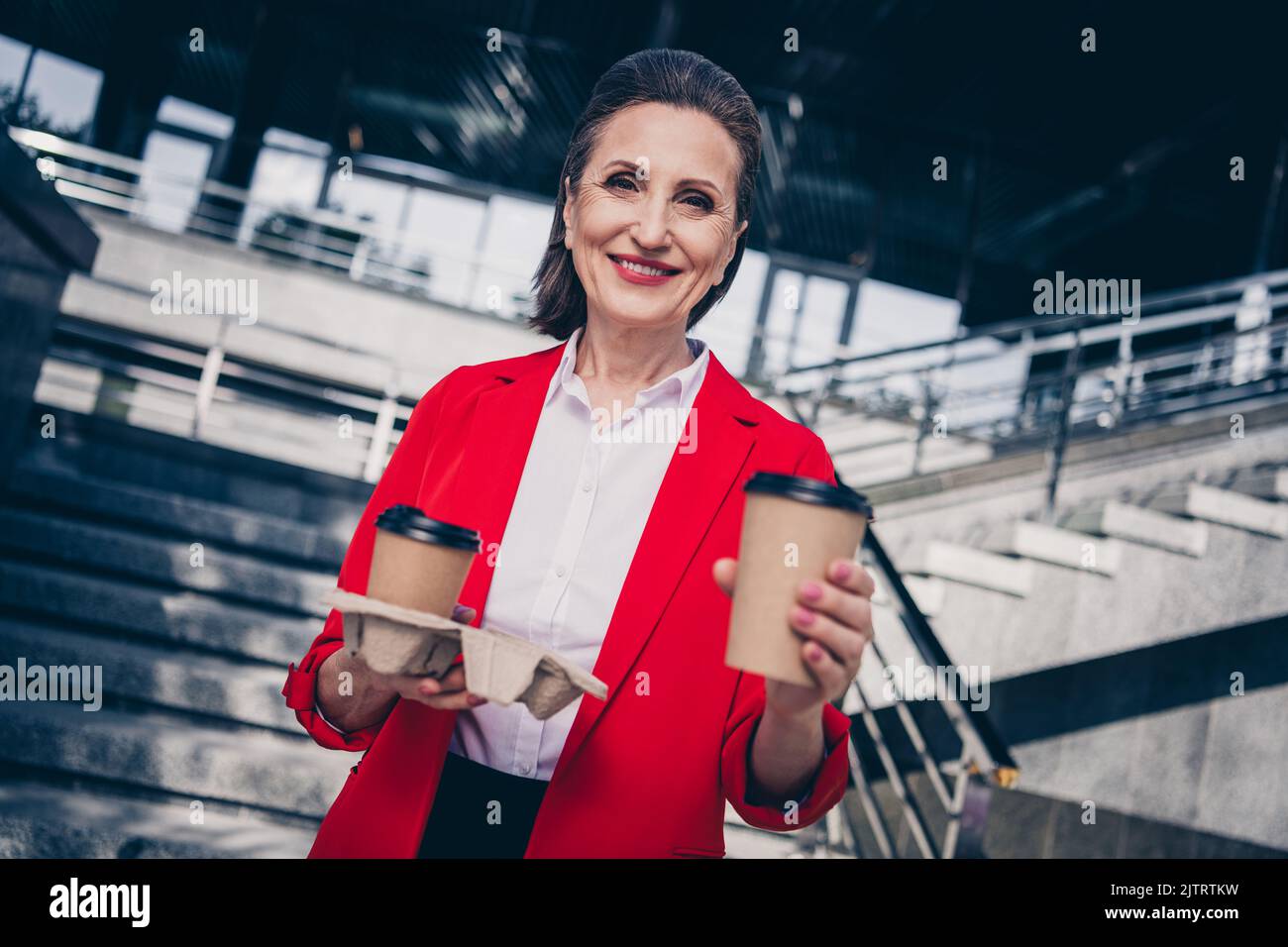 Photo of cute positive senior partner woman dressed red blazer inviting ...
