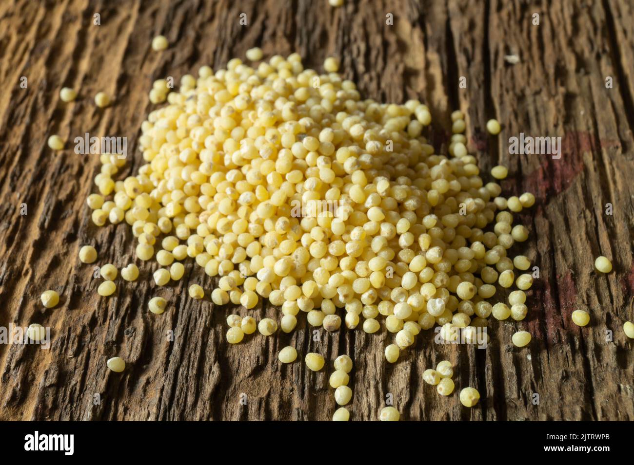Still life with food on an old board. Round grain grain of yellow color ...