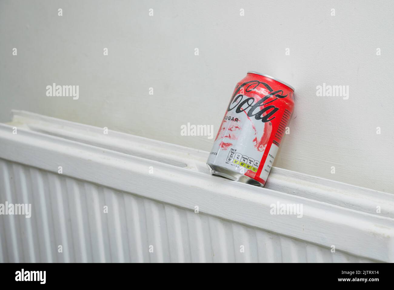 One cola can on heater radiator Stock Photo - Alamy