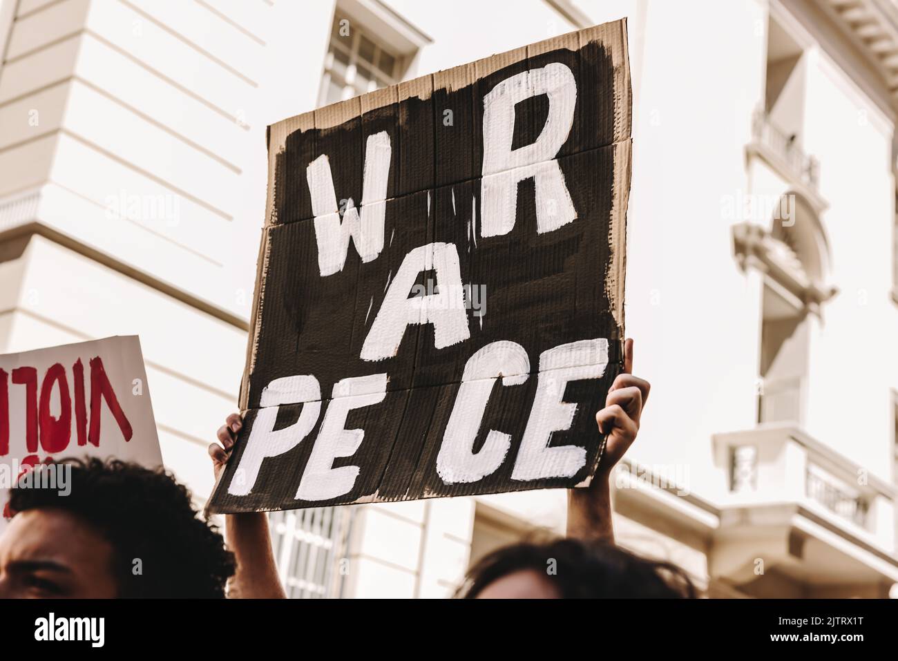 Marching the streets for peace. Activists raising banners and placards ...