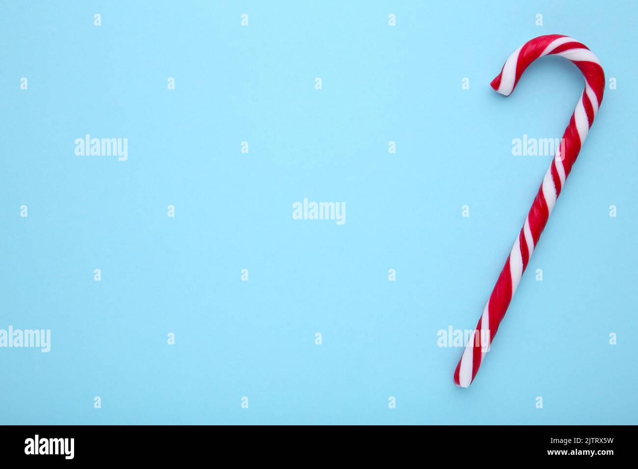 Red candy canes on a blue background, Sweets concept Stock Photo - Alamy