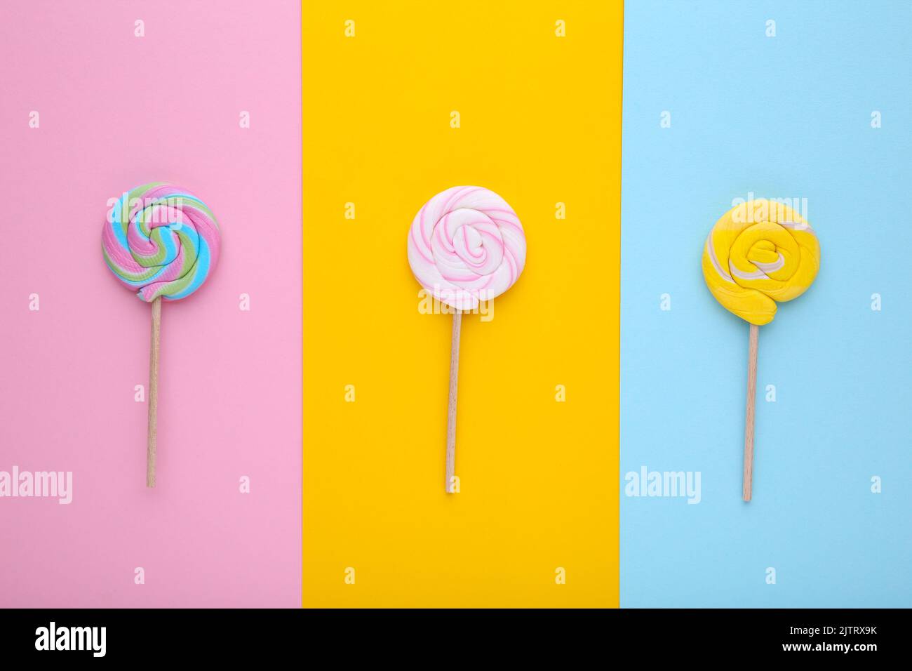 Many lollipops on colorful background. Studio shot Stock Photo - Alamy