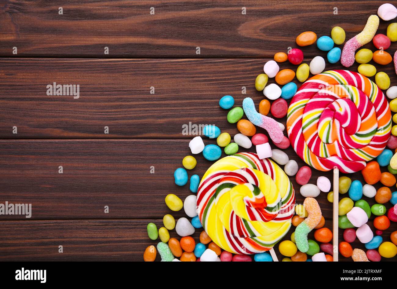Colorful lollipops and different colored round candy on brown Stock ...