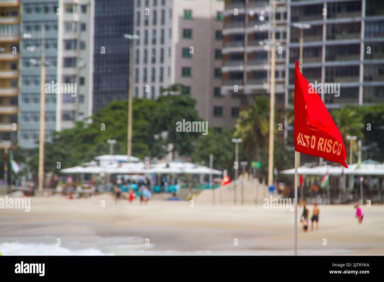 red signal flag written in portuguese "high risk" on copacabana beach ...